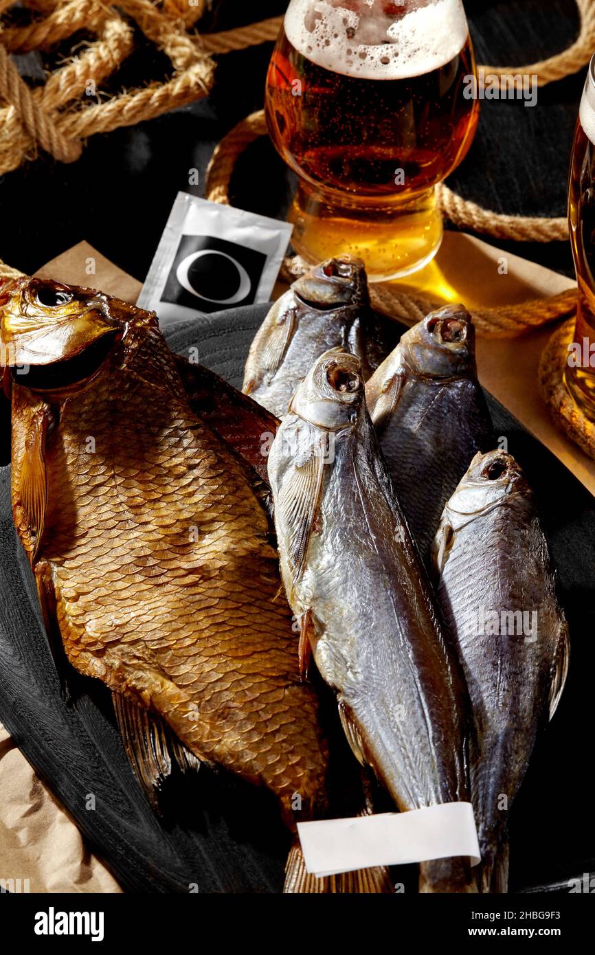 Various whole air-dried and smoked fish served with amber lager Stock ...