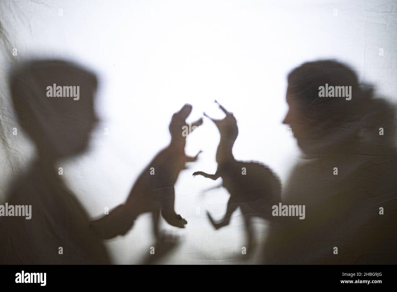 Mother and son playing with shadows behind a bed sheet Stock Photo - Alamy