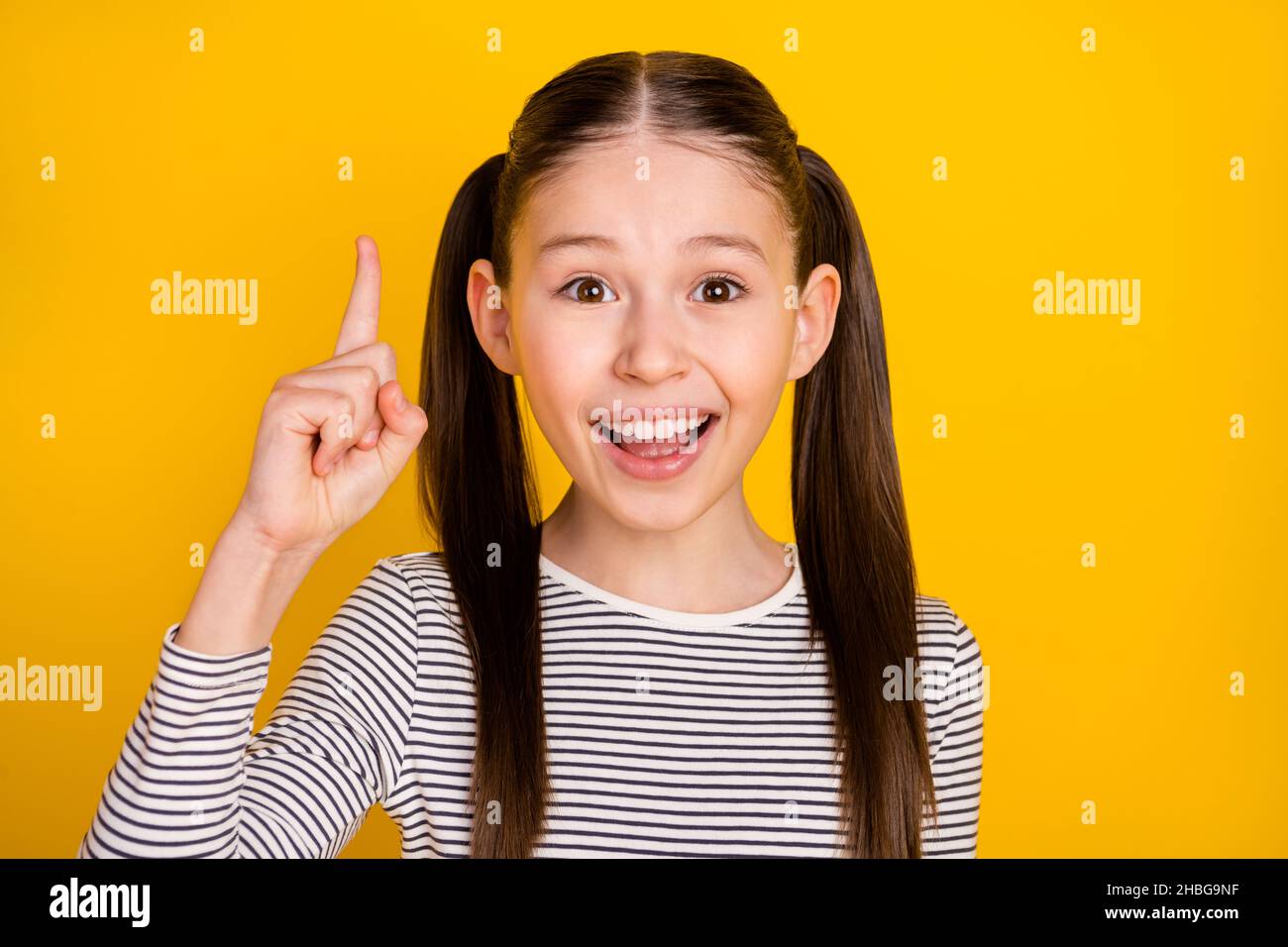 Photo of young girl happy positive smile point finger have an idea ...