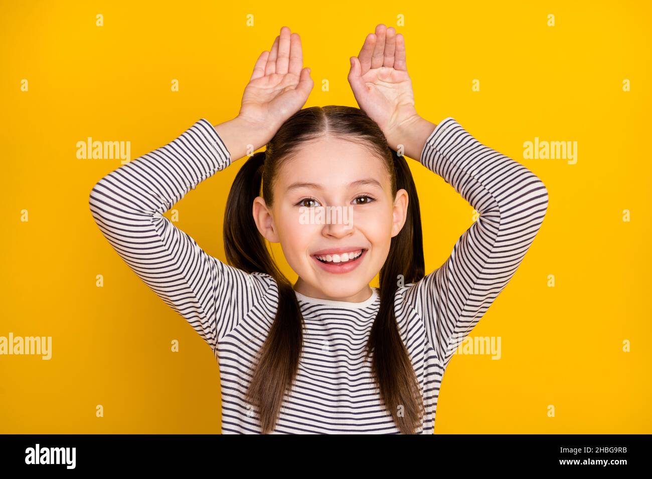 Photo of young girl happy positive smile grimace hold hands bunny ears ...