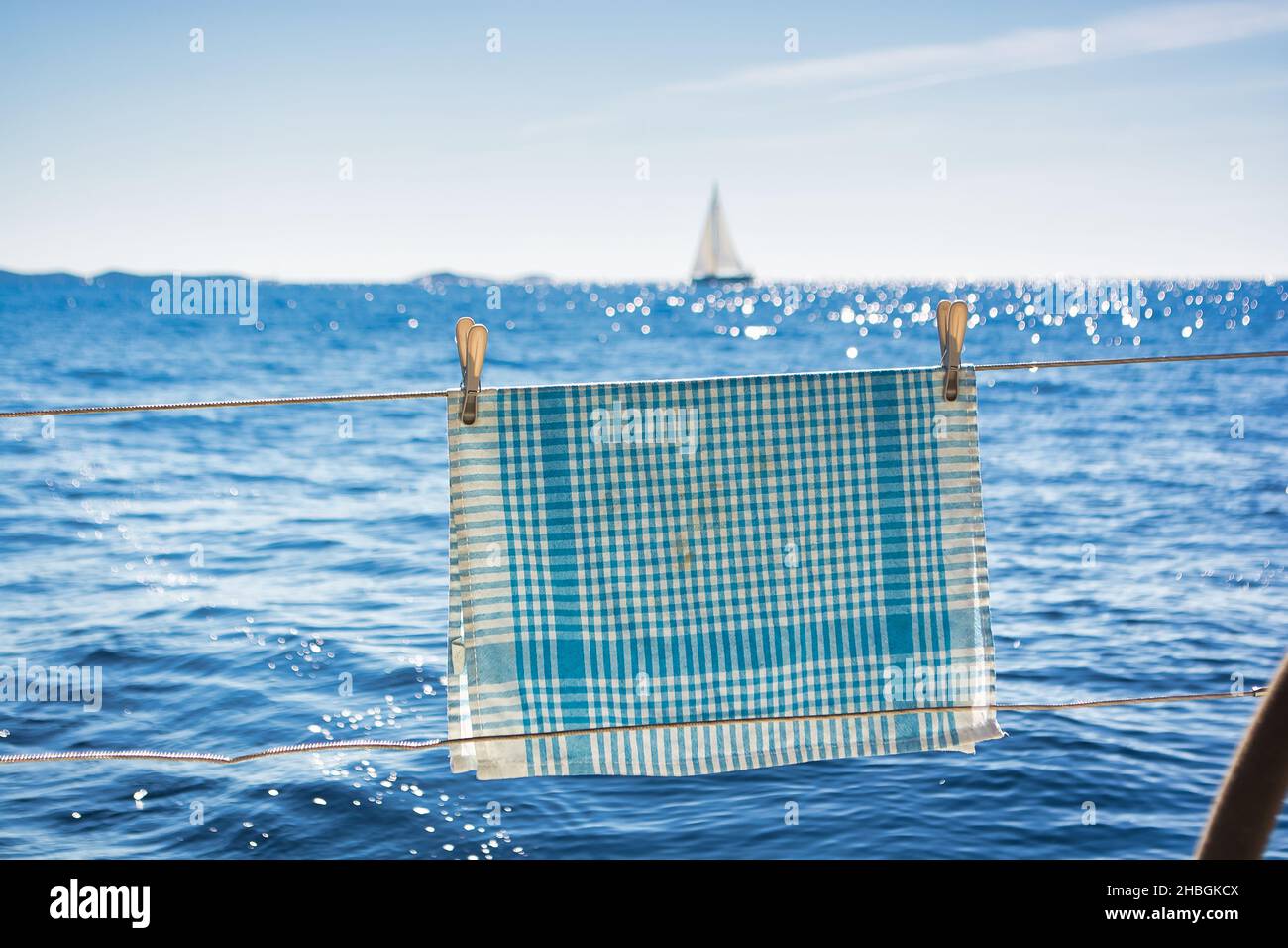 Blue and white dishcloth drying on a boat in Croatia Stock Photo - Alamy