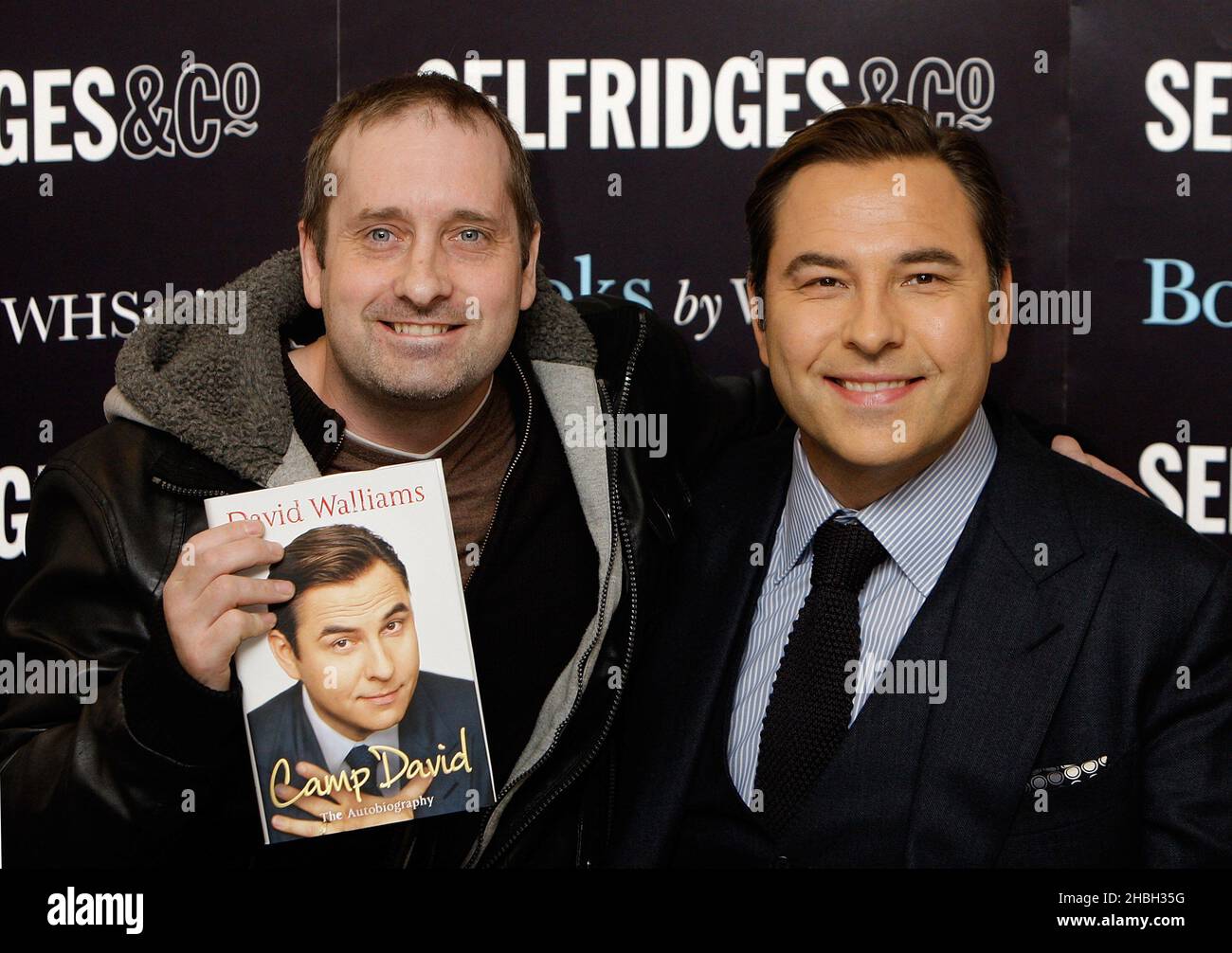 David Walliams poses with a fan as he signs copies of his autobiography ...