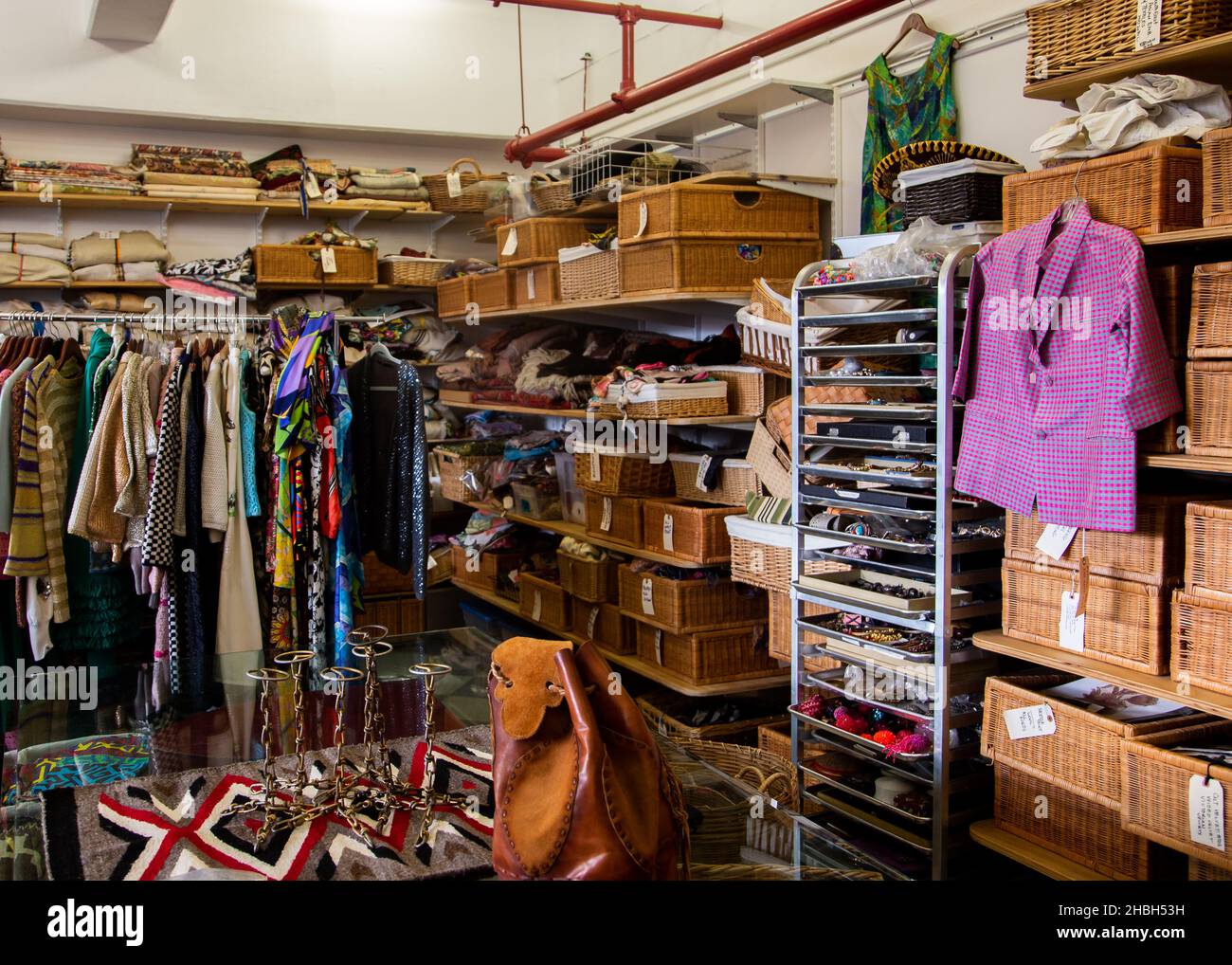 The interior and items of a vintage thrift clothing store with ...