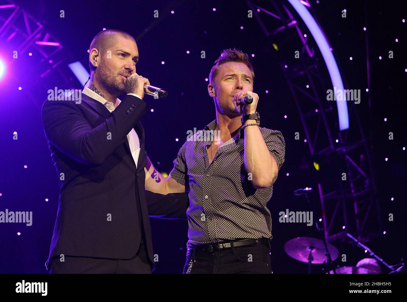 Shane Lynch of Boyzone with Ronan Keating (right) performing on stage ...