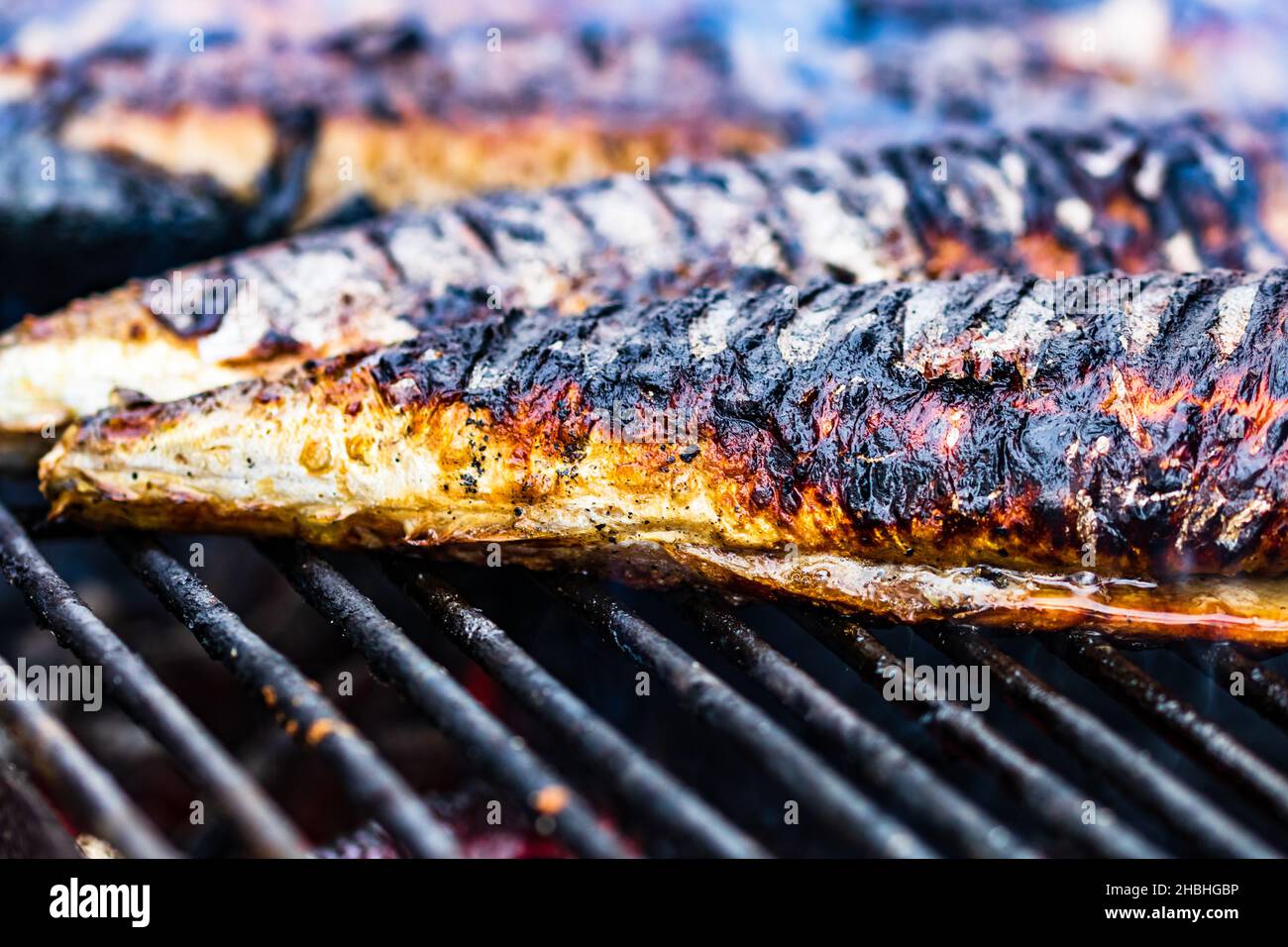 A selective focus shot of grilled fish on charcoal grill Stock Photo - Alamy