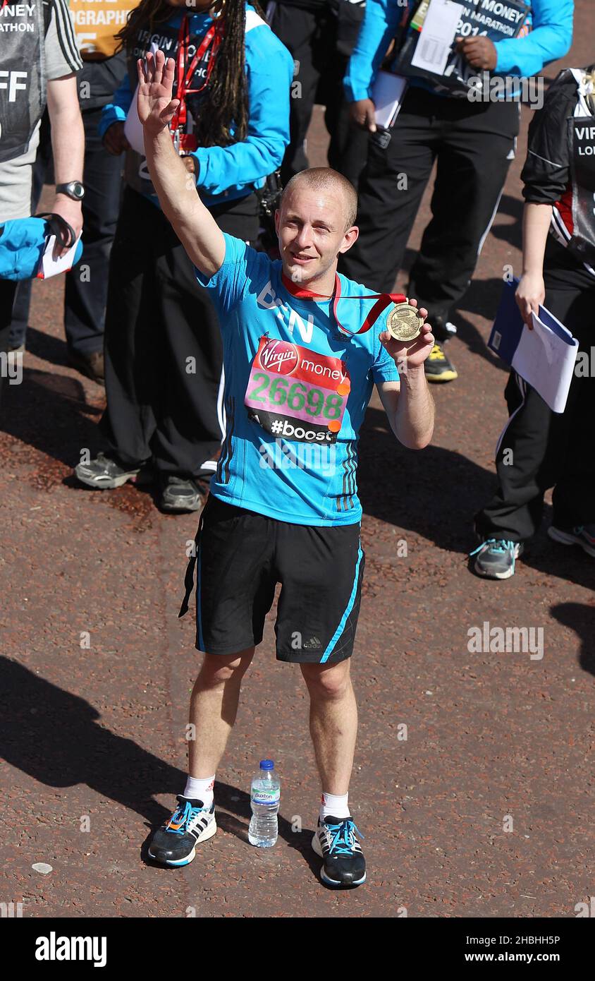 Ben Quilton with medal at the finishing line of the Virgin Money London ...