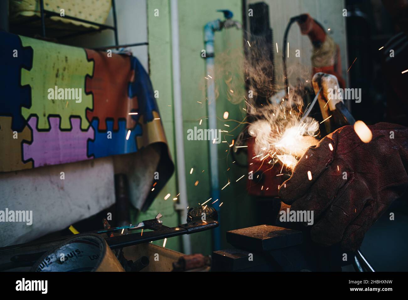 Man hand Industrial worker welding metal at factory workshop at Steel ...