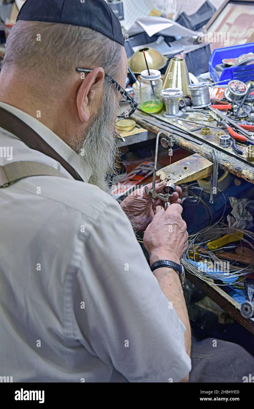 An orthodox Jewish master craftsman works in his home studio in ...