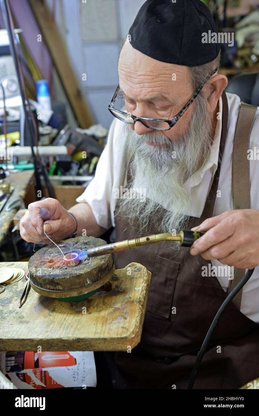 An orthodox Jewish master craftsman works in his home studio in ...