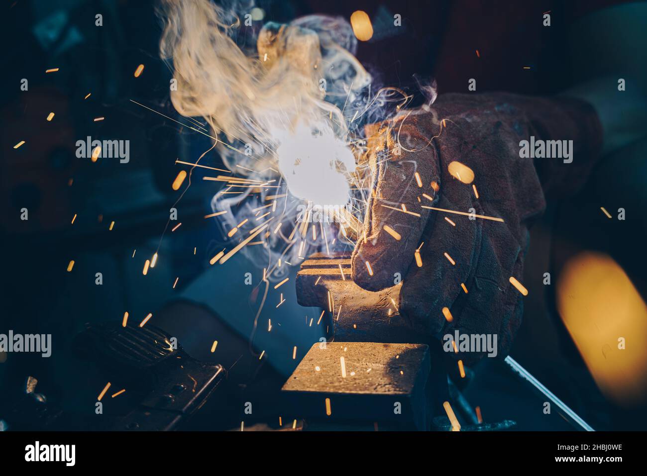 Man hand Industrial worker welding metal at factory workshop at Steel ...