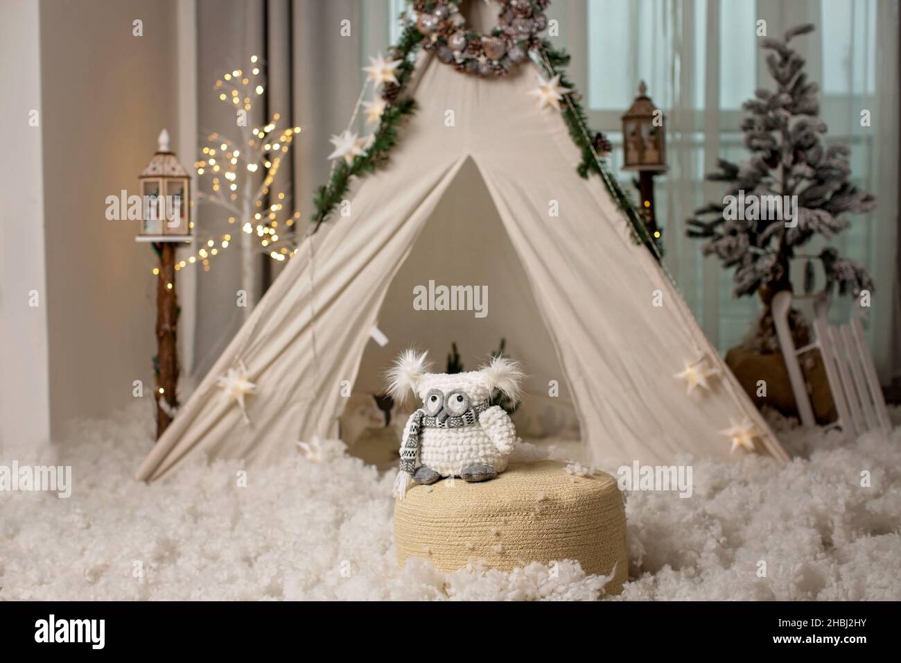 Winter scene with teepee, light tree, christmas tree and street lamps ...