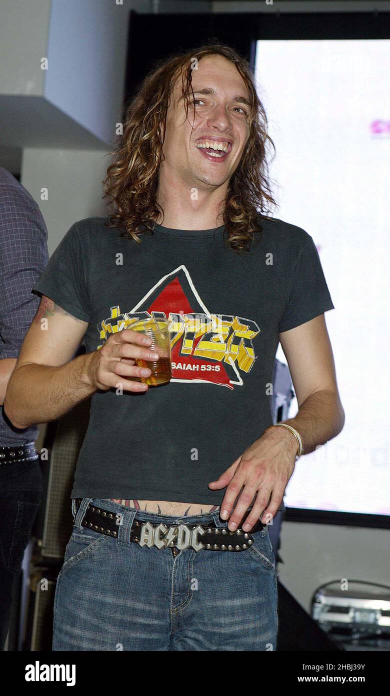 The Darkness vocalist Justin poses at their signing of 'Permission to ...