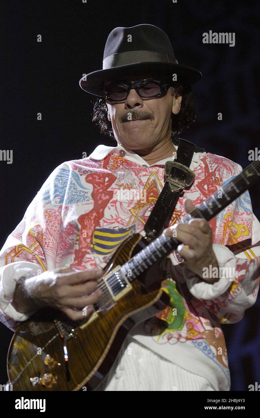 Carlos Santana performs live on stage with guitar at the Wembley Arena ...