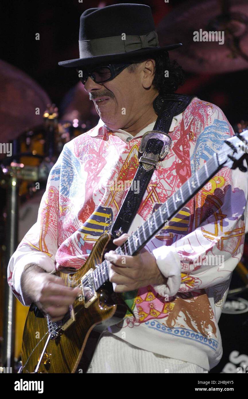 Carlos Santana performs live on stage with guitar at the Wembley Arena ...