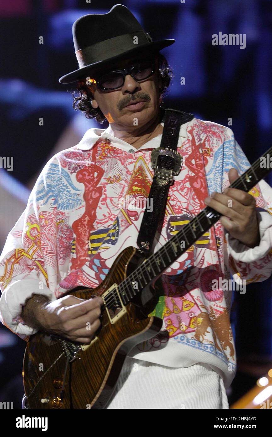Carlos Santana performs live on stage with guitar at the Wembley Arena ...