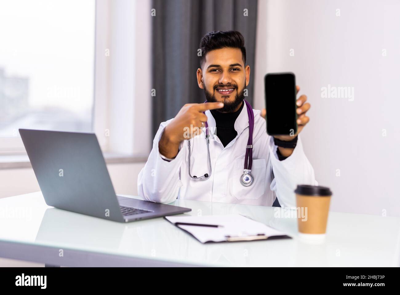 Doctor showing mobile screen in hand hi-res stock photography and ...