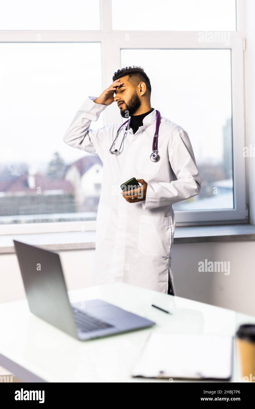 Overworked doctor sitting in his office Stock Photo - Alamy