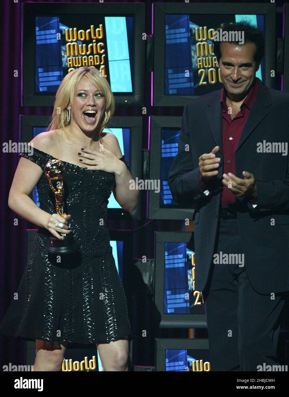 Hillary Duff receives award from David Copperfield on stage at the 2004 ...