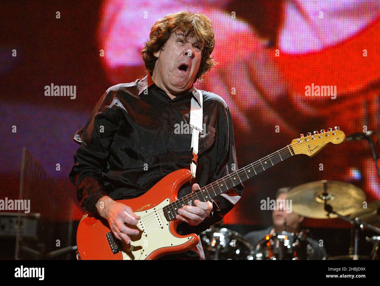 Gary Moore performs on stage as part of "The Miller Strat Pack" Fender ...