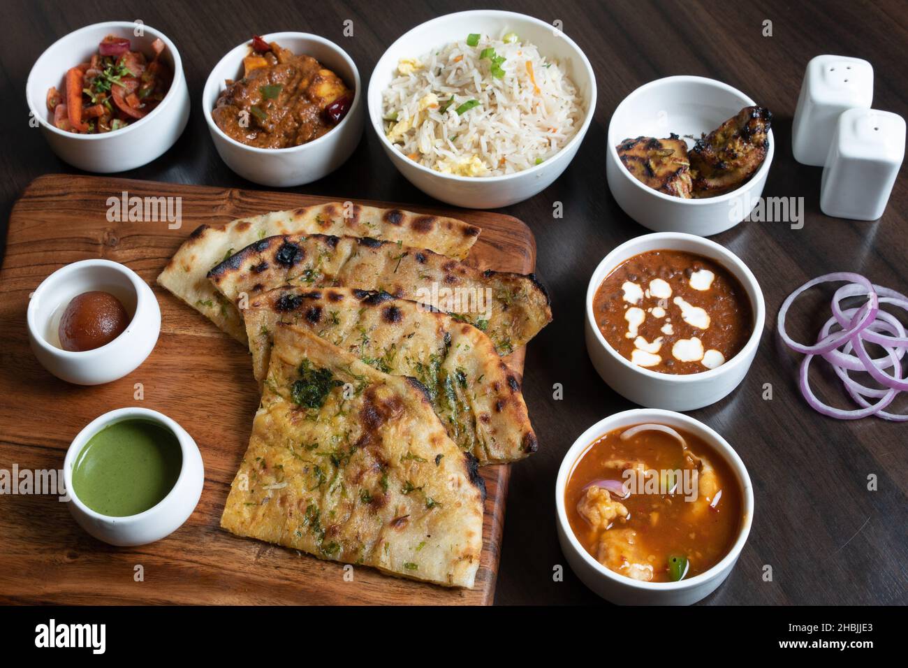 Shot of the roti sliced and types of side dishes kept on the table for ...