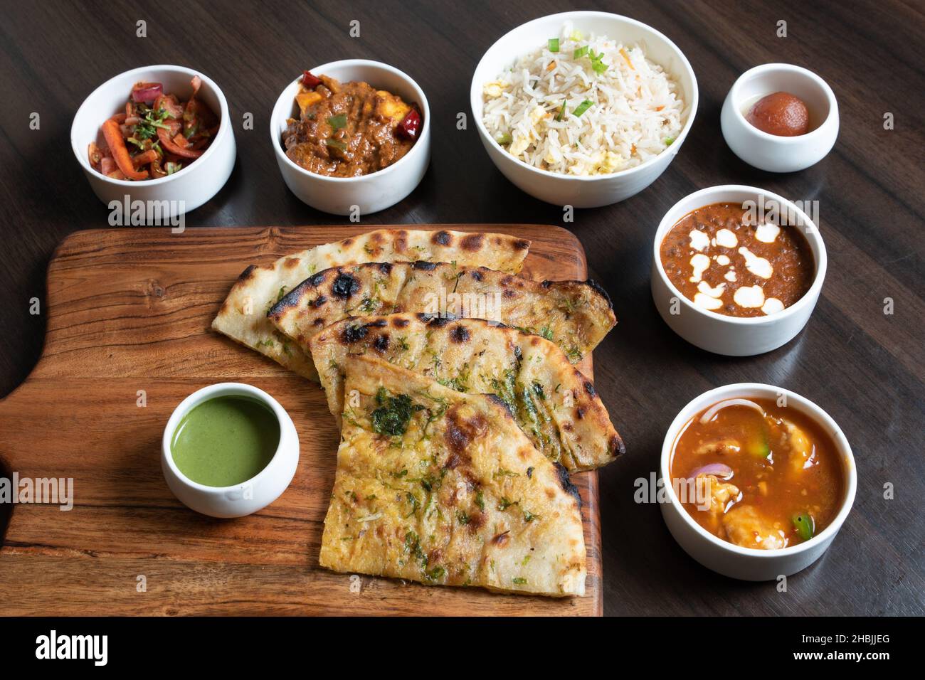 Shot of the roti sliced and types of side dishes kept on the table for ...