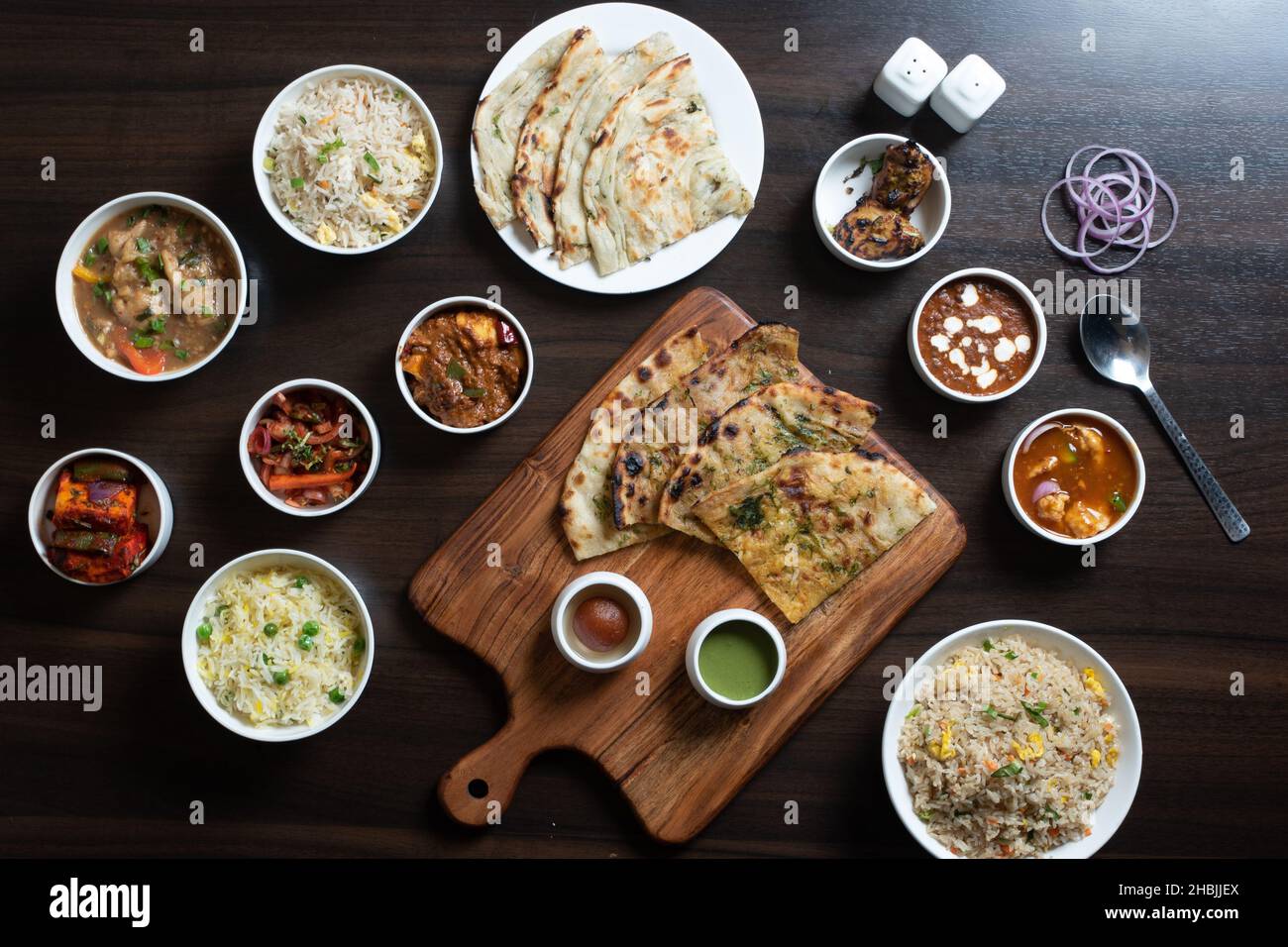 Click of variety of side dishes and food with sliced roti and onions ...