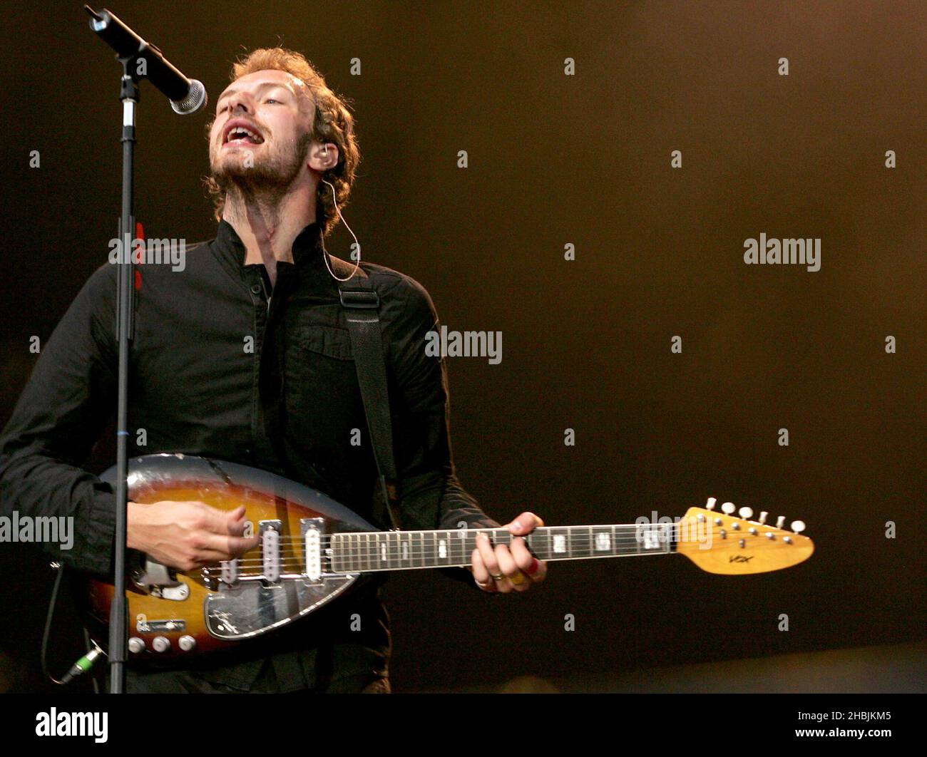 Chris Martin of Coldplay performs on stage as Coldplay perform on stage ...