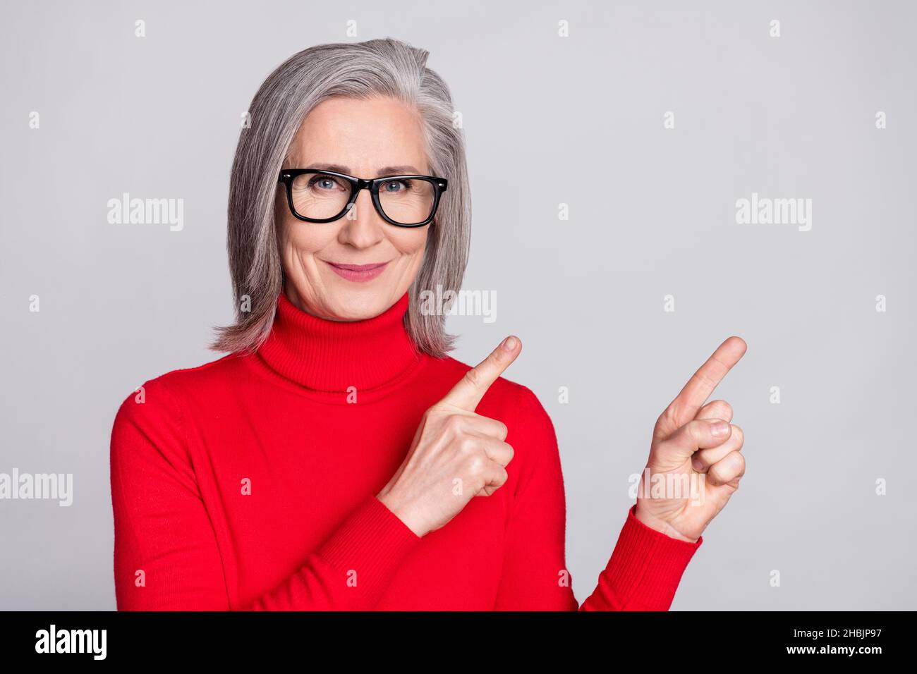 Photo of attractive cheerful old woman point finger empty space sale ...