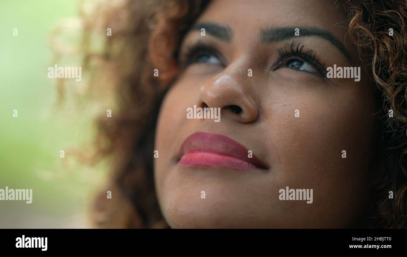 Brazilian person close-up face looking at sky with HOPE Stock Photo - Alamy