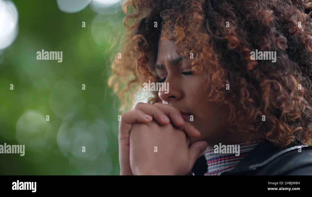 Brazilian woman looking up at sky with Hope and Faith Stock Photo - Alamy