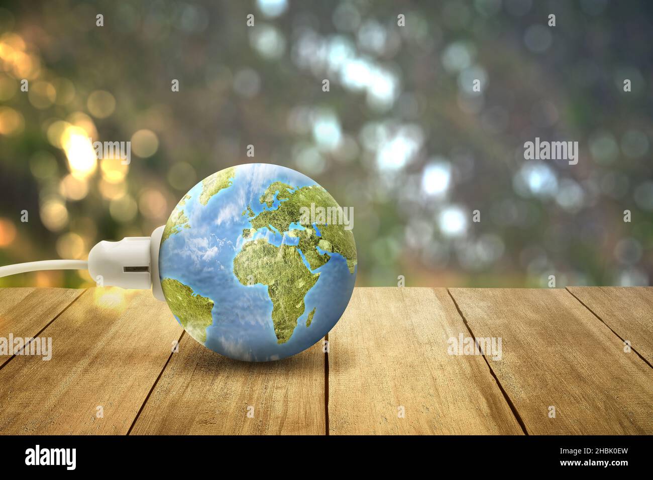 Electric plug into an earth power socket. Green Power Concept Stock ...