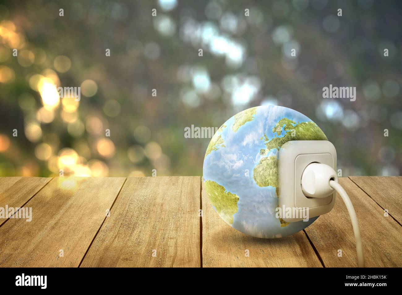 Electric plug into an earth power socket. Green Power Concept Stock ...