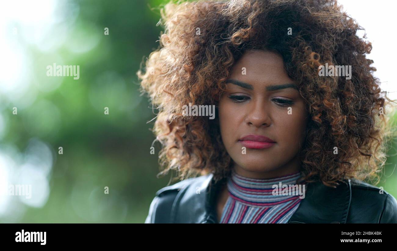 Pensive African descent woman. Contemplative Brazilian girl standing ...