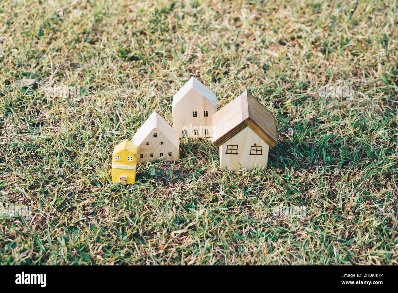 Wooden modern house on green grass with sun light concept image of make ...