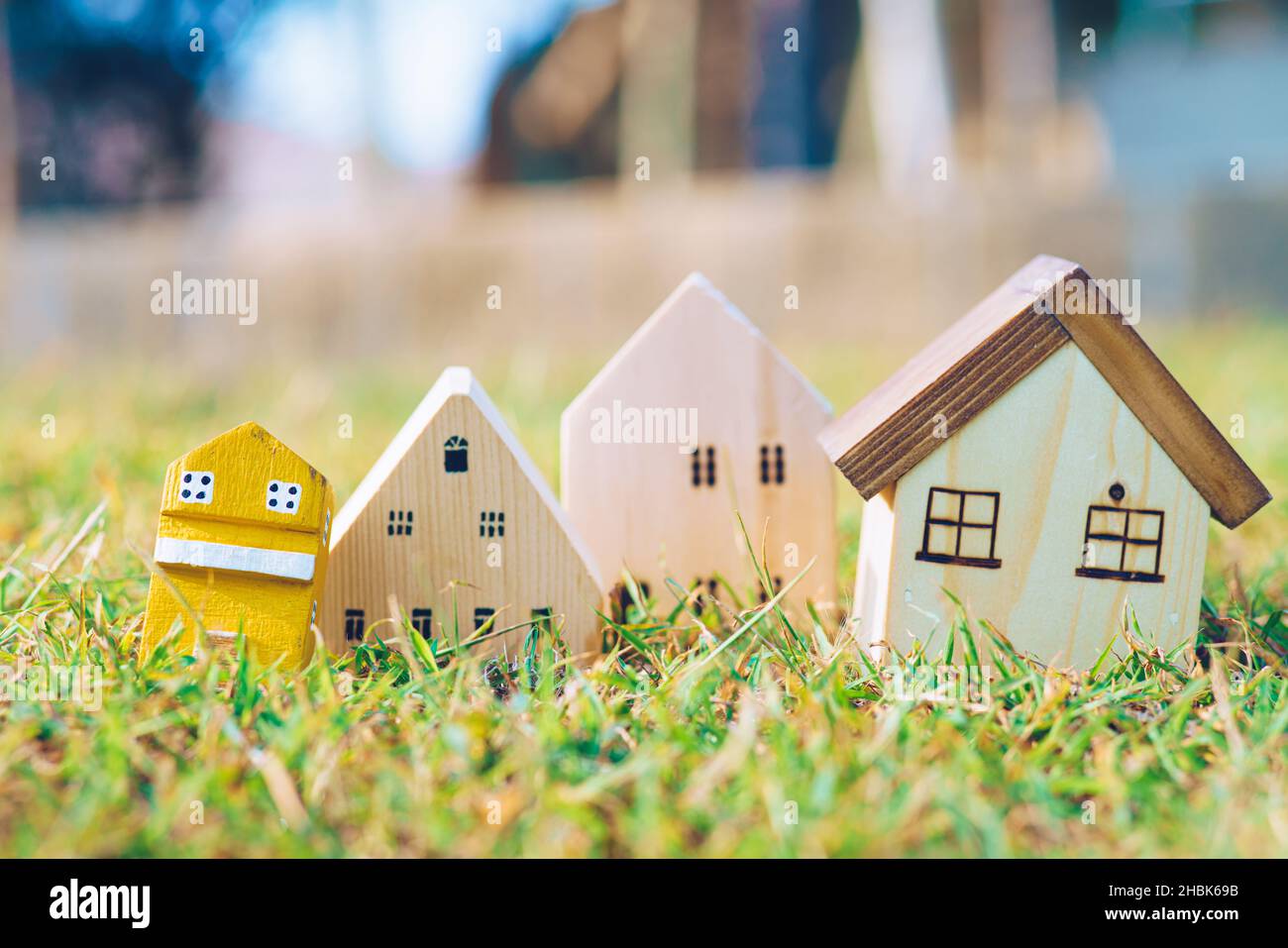 Wooden modern house on green grass with sun light concept image of make ...