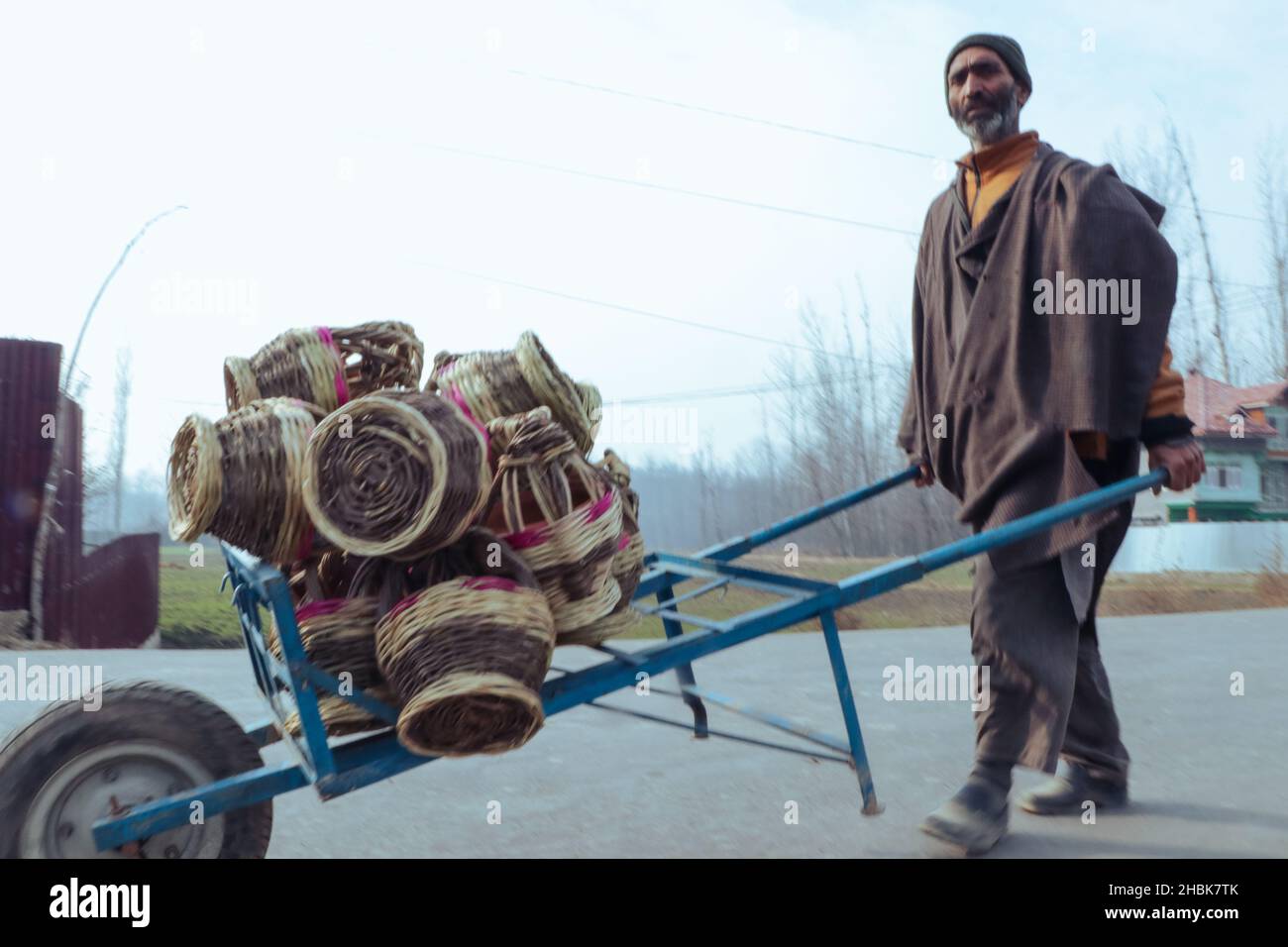 Pulwama, Jammu and Kashmir, India. 20th Dec, 2021. A man carries a ...