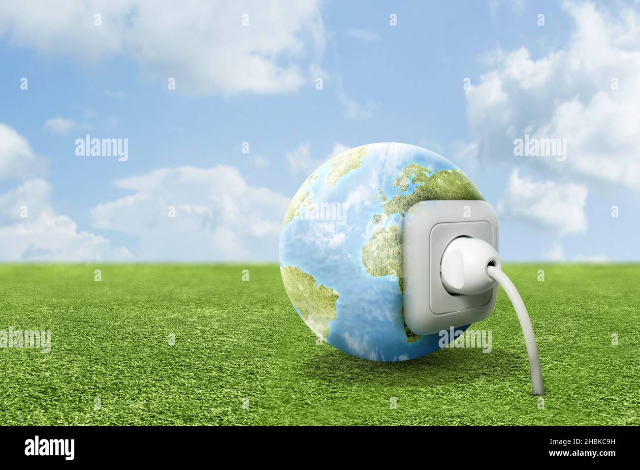 Electric plug into an earth power socket. Green Power Concept Stock ...