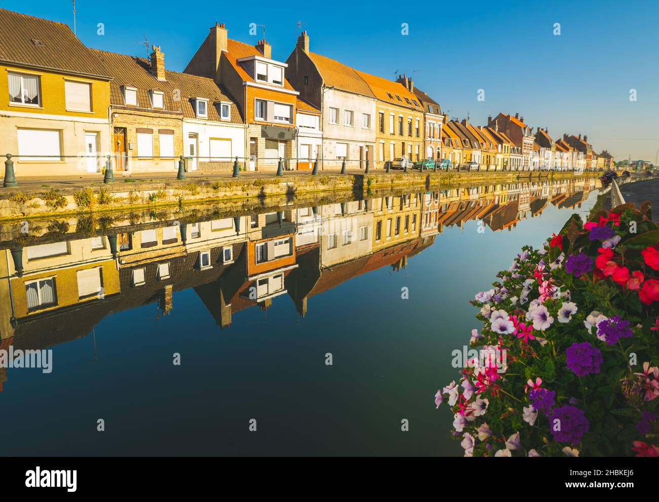 Line of Traditional buildings with cars standing and canal in ...