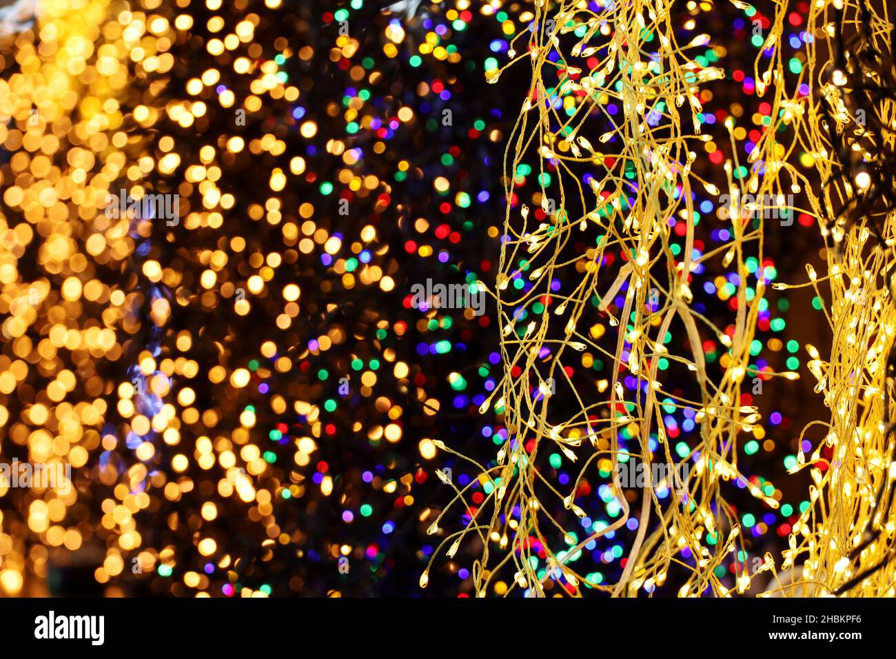 Festive lights on electric garlands. Colorful Christmas illumination ...