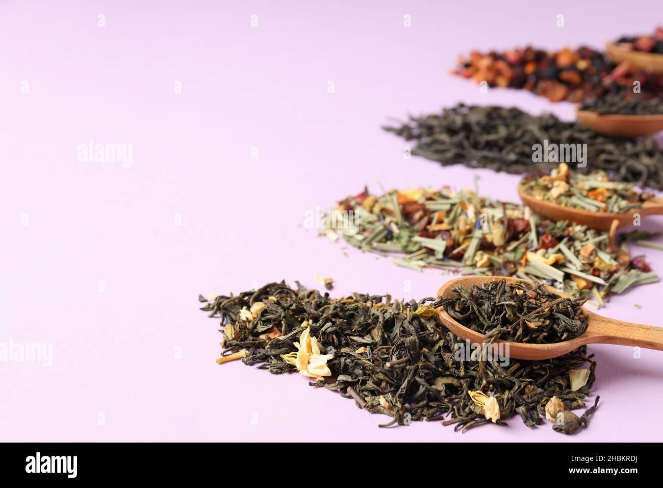 Concept of cooking tea with different types of tea on purple background ...