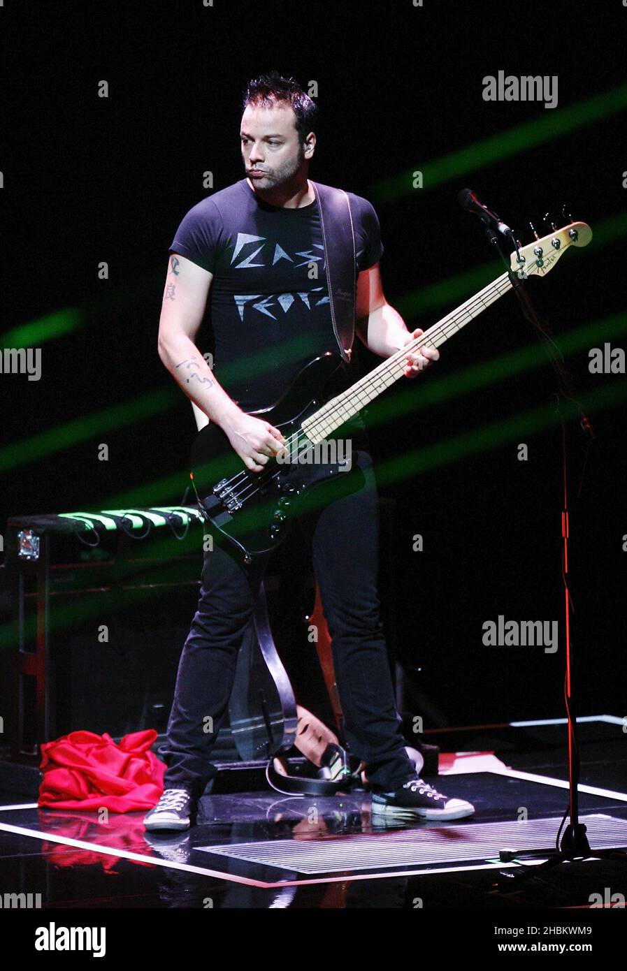 Christopher Wolstenholme of Muse perform on stage at the 02 Arena ...