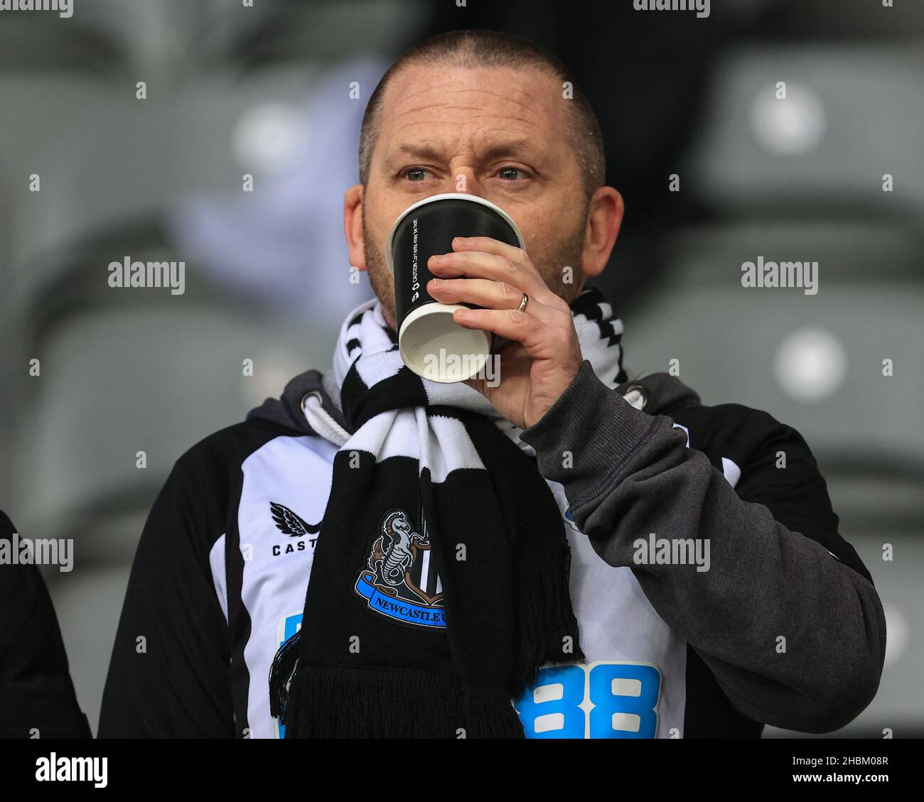 A Newcastle fan taking a drink Stock Photo - Alamy