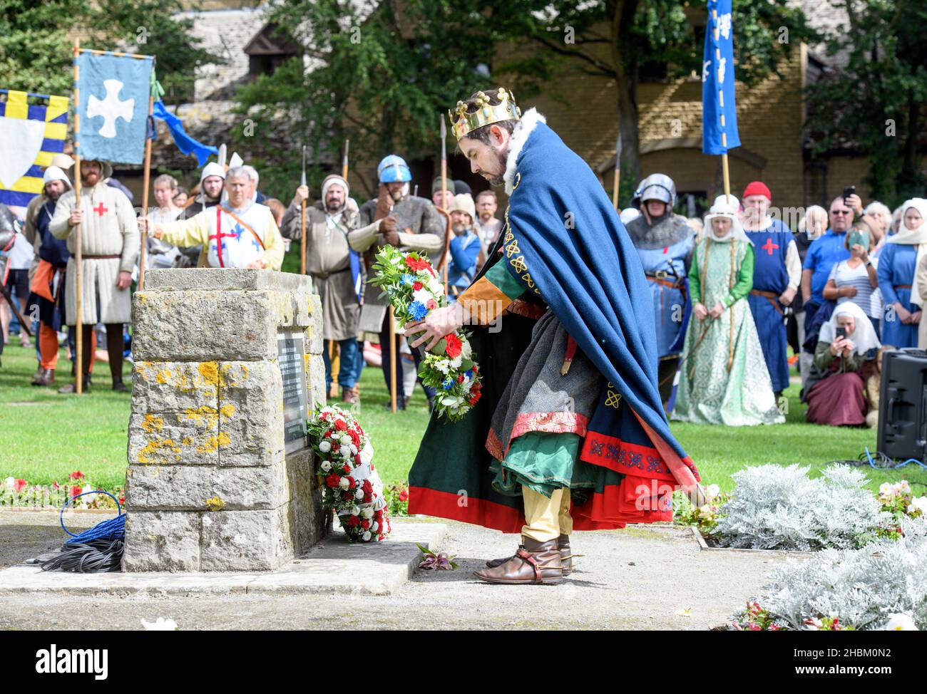 A medieval actor lays a wreath at the Simon de Montfort memorial at ...