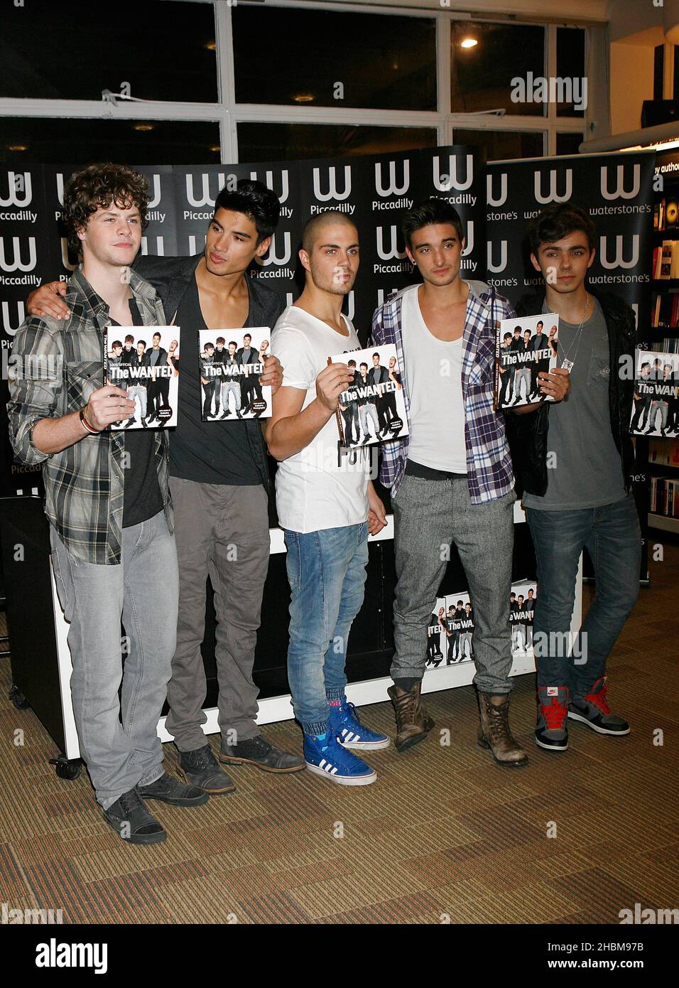 (L-R) Jay, Siva, Max, Tom and Nathan from the Wanted sign copies of ...
