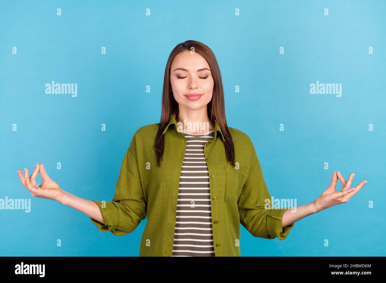 Photo of calm peaceful pretty young woman make om signs meditation ...