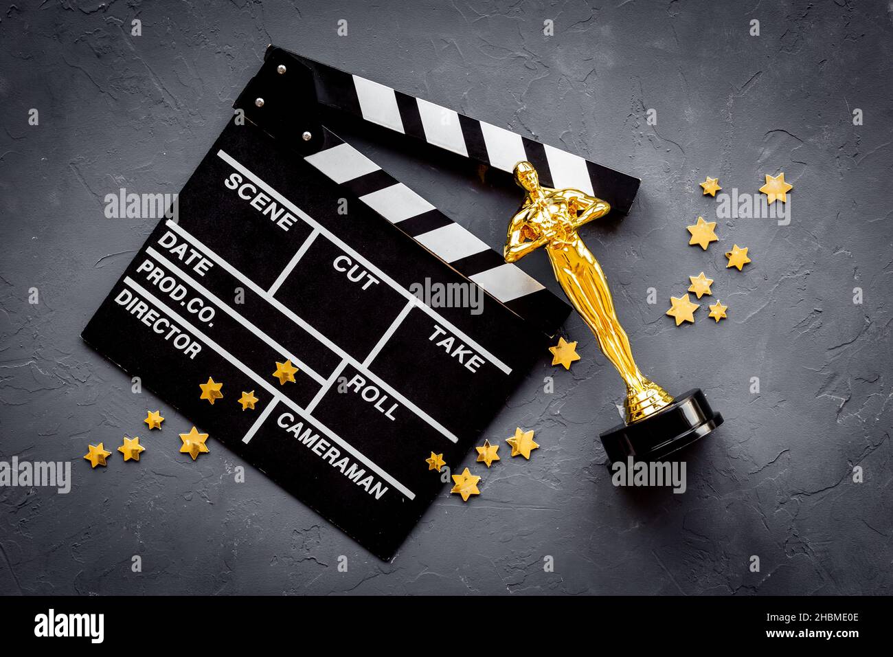 Movie clapper board with golden film award statue Stock Photo - Alamy