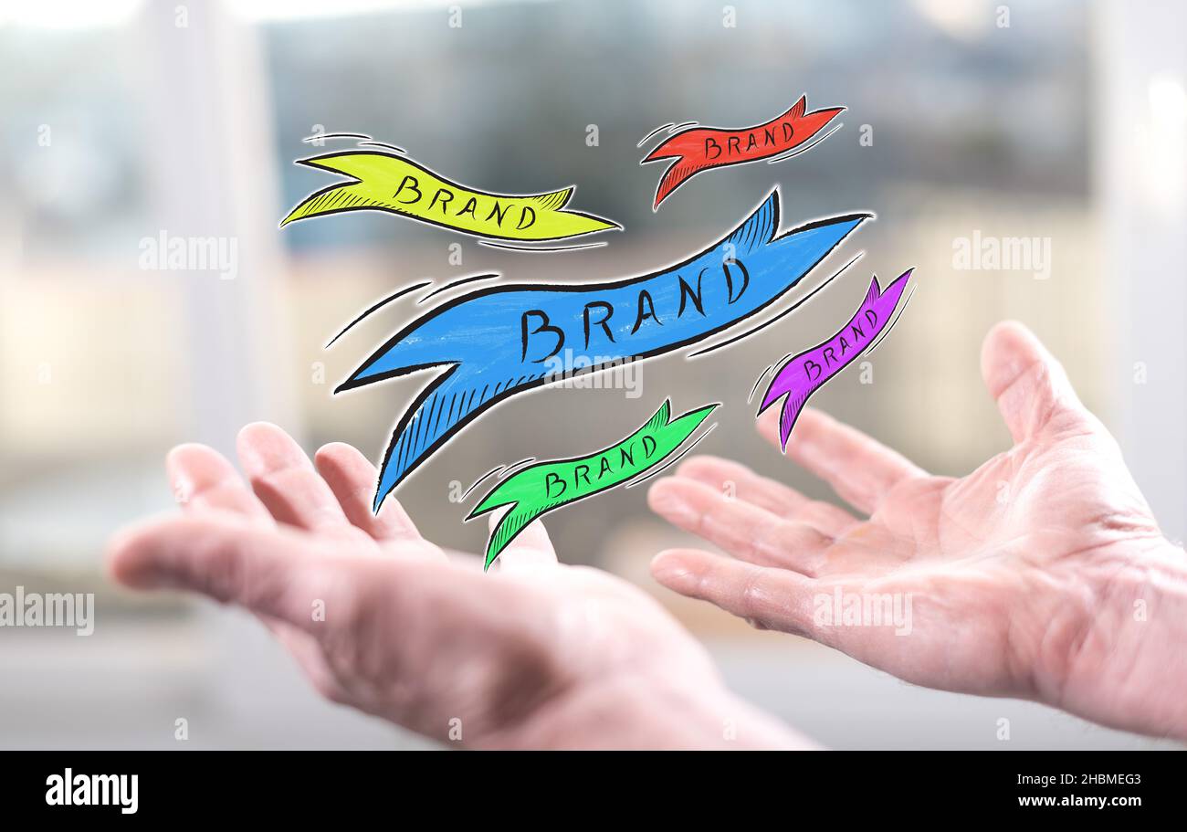 Brand concept above the hands of a man Stock Photo - Alamy