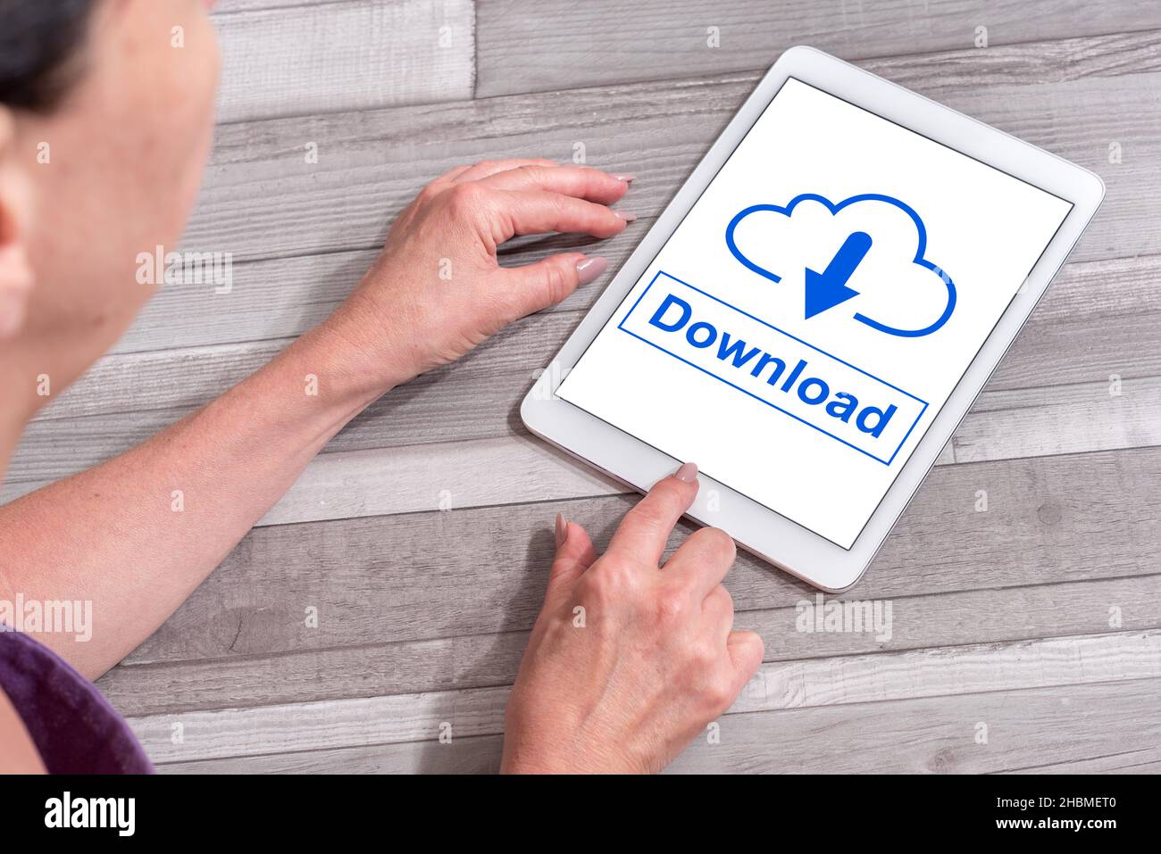 Woman using a tablet showing data download concept Stock Photo - Alamy