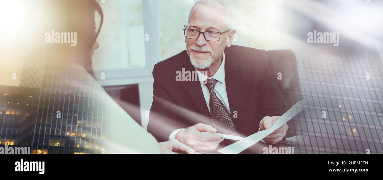 Consultant advising young woman at office, light effect; multiple ...