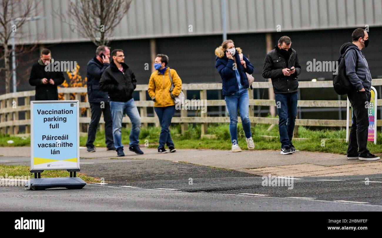 People queue outside a covid-19 booster walk-in clinic at a centre in ...